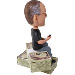 Custom bobblehead sitting on dollars money - Bbobbler