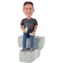Custom bobblehead sitting on dollars money - Bbobbler